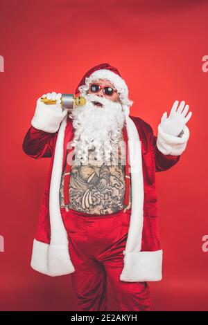 Funny crazy santa claus with tattoo having fun on a red colored ...