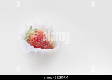 High angle shot of a strawberry floating in a bowl full of milk Stock ...