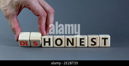 Be honest or dishonest symbol. Businessman turns cubes and changes ...