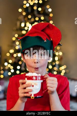 Christmas teen boy in Santa red hat isolated on white background. Happy ...