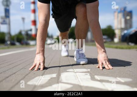 Man guy going to start running at the stadium and standing in the pose ...