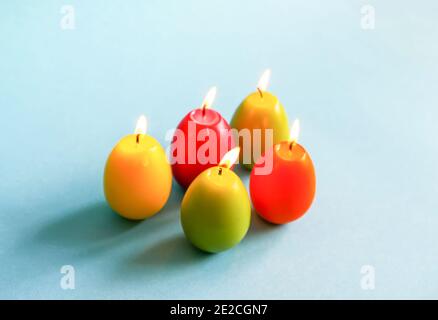 Traditional Easter decor. Bright burning paraffin candles in the shape ...