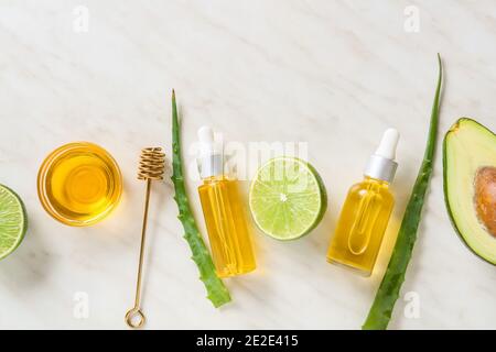 Many bottles of aloe vera essential oil on white background. Pattern ...