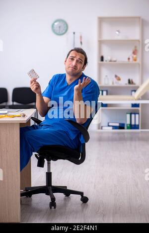 Young sick doctor being unhappy after night shift Stock Photo - Alamy