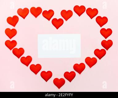 Pink hearts and a sheet of paper, Valentine's day Stock Photo - Alamy