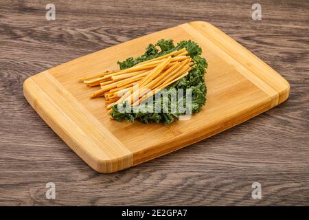 Caucasian Chechel cheese sticks over board Stock Photo - Alamy