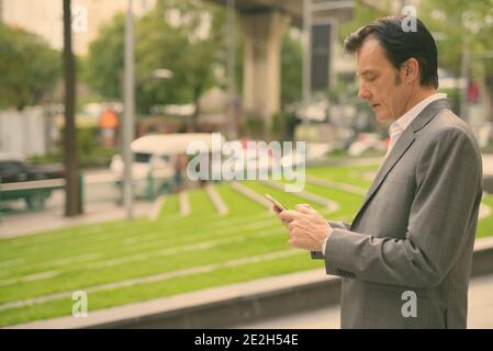 Mature handsome businessman exploring around the city Stock Photo - Alamy