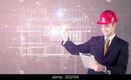 Handsome architect with helmet drawing CLOUD GAMING inscription, new ...