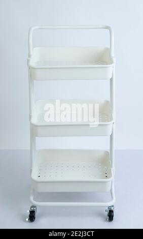 White plastic racks with wheels isolated on white background Stock ...