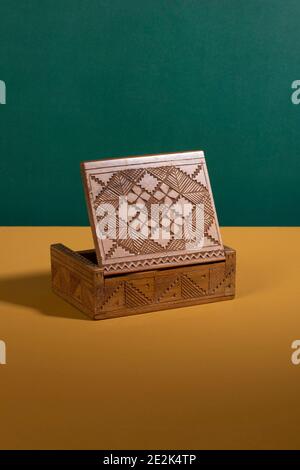 An old vintage handcarved wooden box in a dark brown color and golden ...