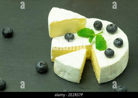 Food banner. Different sorts of cheese and grapes on a wooden ...