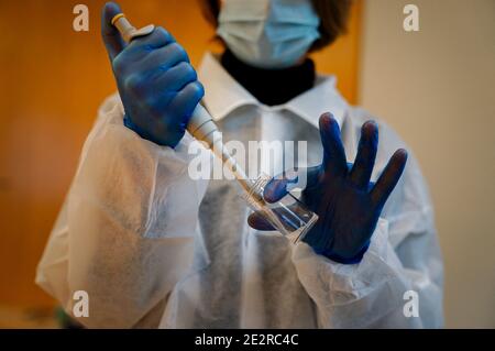 Laborantine performing an EasyCov rapid saliva test for Covid-19, in ...