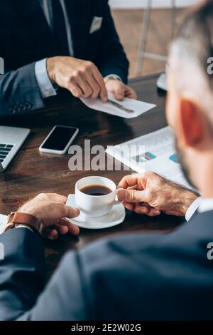 People hands with blank papers on wooden background Stock Photo - Alamy
