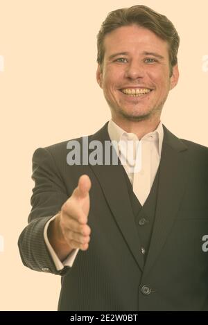 Happy Caucasian businessman giving handshake Stock Photo - Alamy