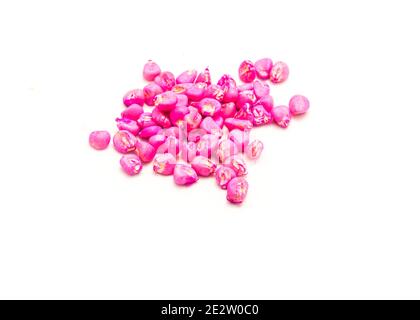 Chemically treated red corn seed ready for seeding Stock Photo - Alamy
