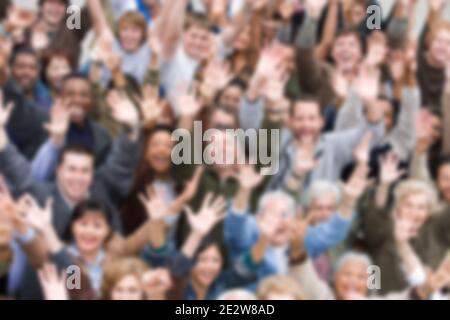 Blurred photo of Crowd with arms raised Stock Photo - Alamy