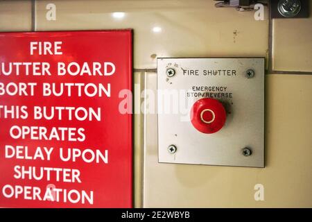 A fire alarm box with instructions to break the glass and press button ...