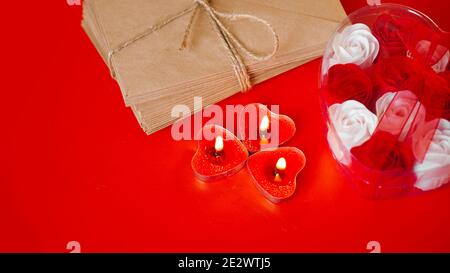 Envelopes with gift and candles on pink background. Valentine's Day ...