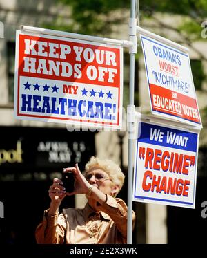 People hold signs during a Tea Party Protest in Freedom Plaza ...