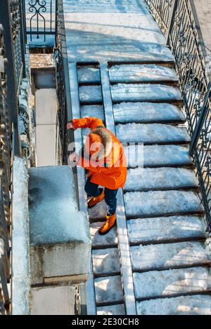 People walk carefully on the icy sidewalk in Prague, Czech Republic ...