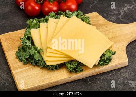Sliced Gauda cheese snack over board Stock Photo - Alamy