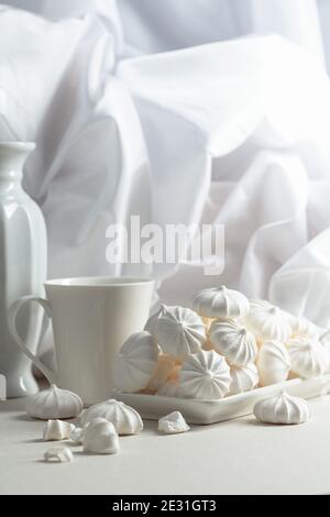 Small white meringues on the table. Selective focus Stock Photo - Alamy