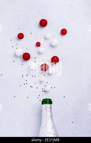 Champagne bottle and star decor on blue background. Flat lay with copy ...