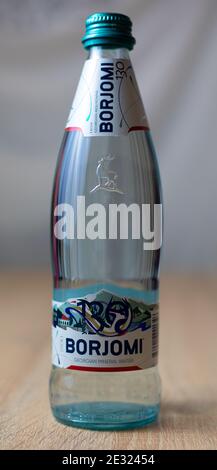 Glass bottle of Borjomi sparkling Georgian mineral water on wooden ...