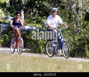 Michelle Obama trails Sasha Obama during a family bike ride in Manuel ...