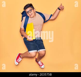 Adorable student boy wearing glasses and backpack smiling happy ...
