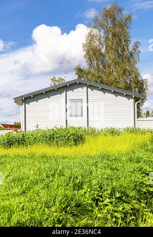 Finnish rustic wooden house in summer sunny day at the countryside ...