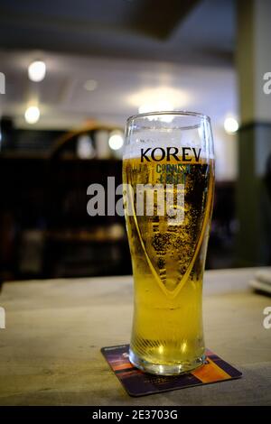 Korev Cornish beer in a glass at Surf Beach Bar, Sennen Cove, Penwith ...
