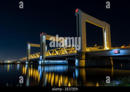 Botlek bridge at night. A Modern vertical lift bridge over the river ...