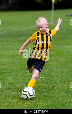Boys kicking soccer ball. Youth soccer game for kids Stock Photo - Alamy