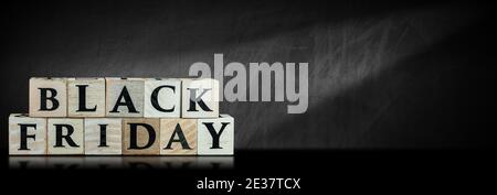 Text Black Friday made of wooden blocks on a blank chalkboard and a ...