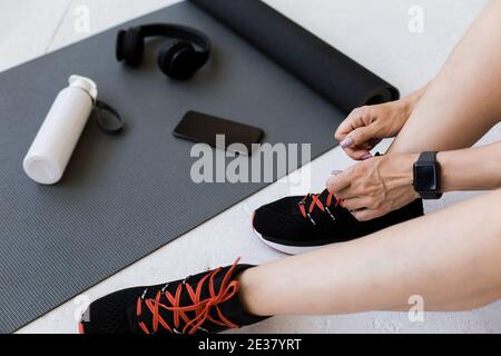 Modern gadgets for training at home. Woman using fitness app on ...
