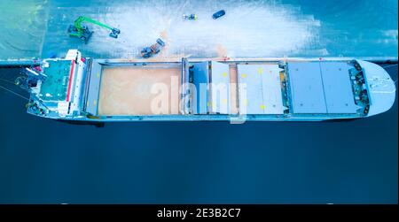 Loading grain into holds of sea cargo vessel through an automatic line ...