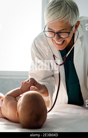 Pediatric examination of a child with a stethoscope. Little boy and ...