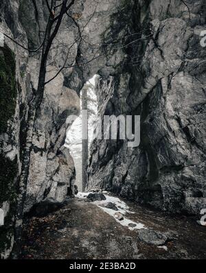 Vertical shot of a pathway through the hole of a cliff Stock Photo - Alamy