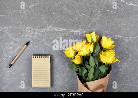 Yellow roses in craft paper and trendy gift box in recycled paper on ...