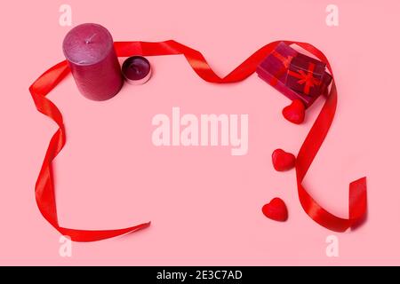 Frame made of gifts, ribbon and hearts on light wooden background ...