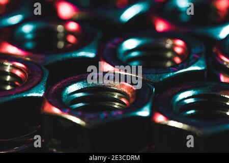 Screw nuts in a dark atmosphere with the red light coming under it ...