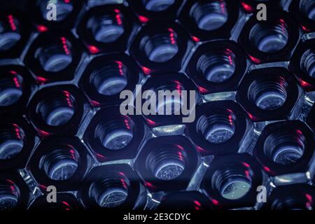 Overhead shot of screw nuts in a dark atmosphere with the red light ...