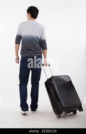 Portrait of young bisiness man pulling valise high quality photo Stock ...