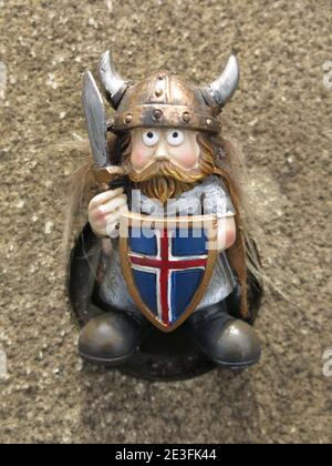 A miniature Viking figure wearing a horned helmet, in battle regalia ...
