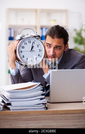 Workload employee in time management concept Stock Photo - Alamy