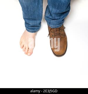 one foot with shoe and one barefoot Stock Photo - Alamy