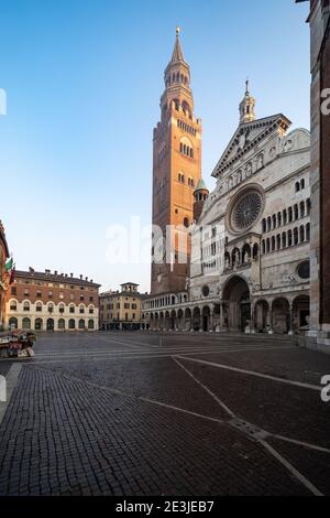 The medieval facade and Torrazzo bell tower of Cremona Cathedral behind ...