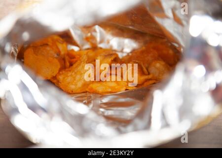 Flavored potato chips at the back of an open bag Stock Photo - Alamy