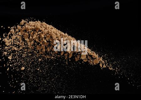 Pile of soil dropping isolated on black background Stock Photo - Alamy